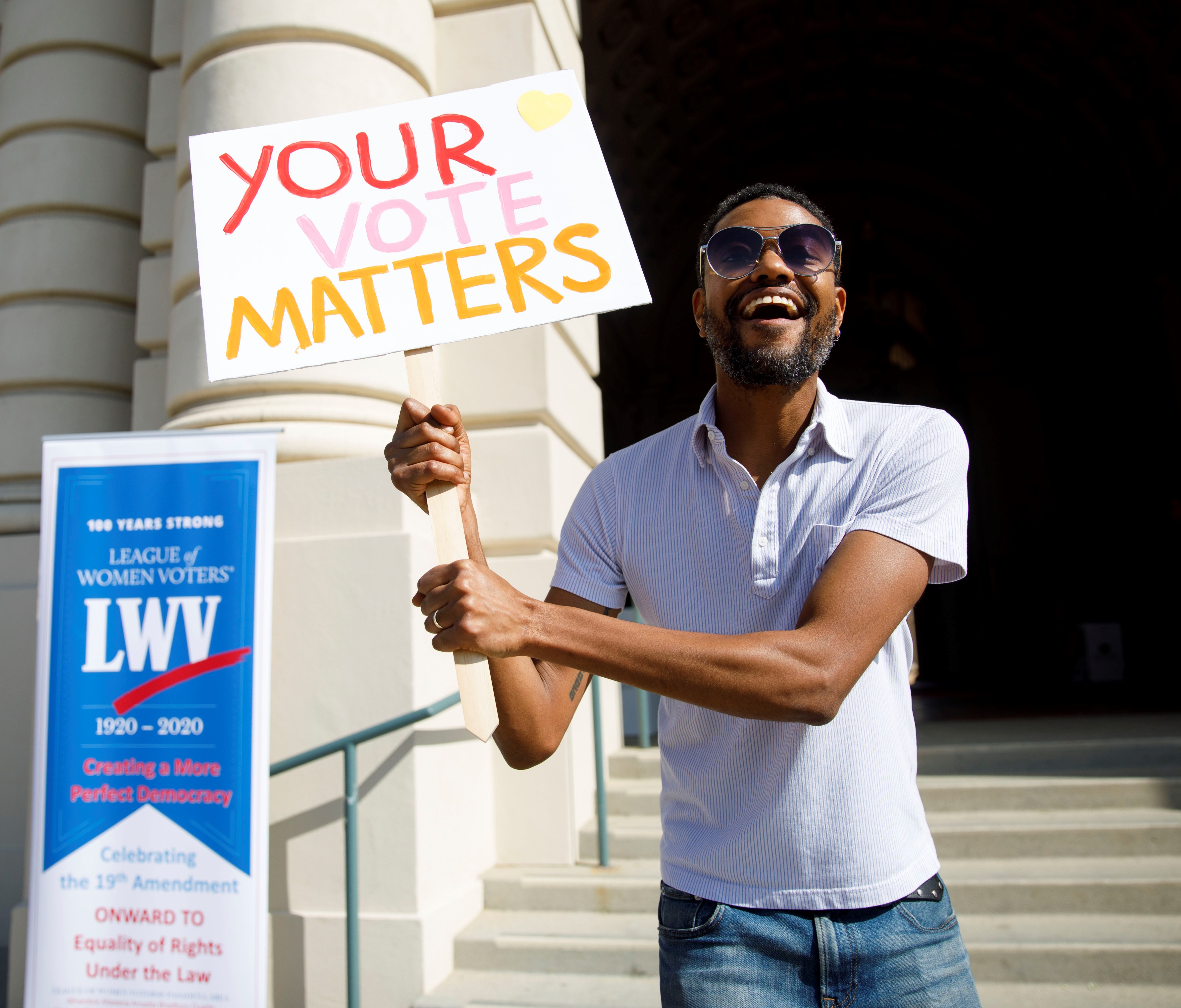 photo_man_holding_your_vote_matters_sign.jpg | MyLO